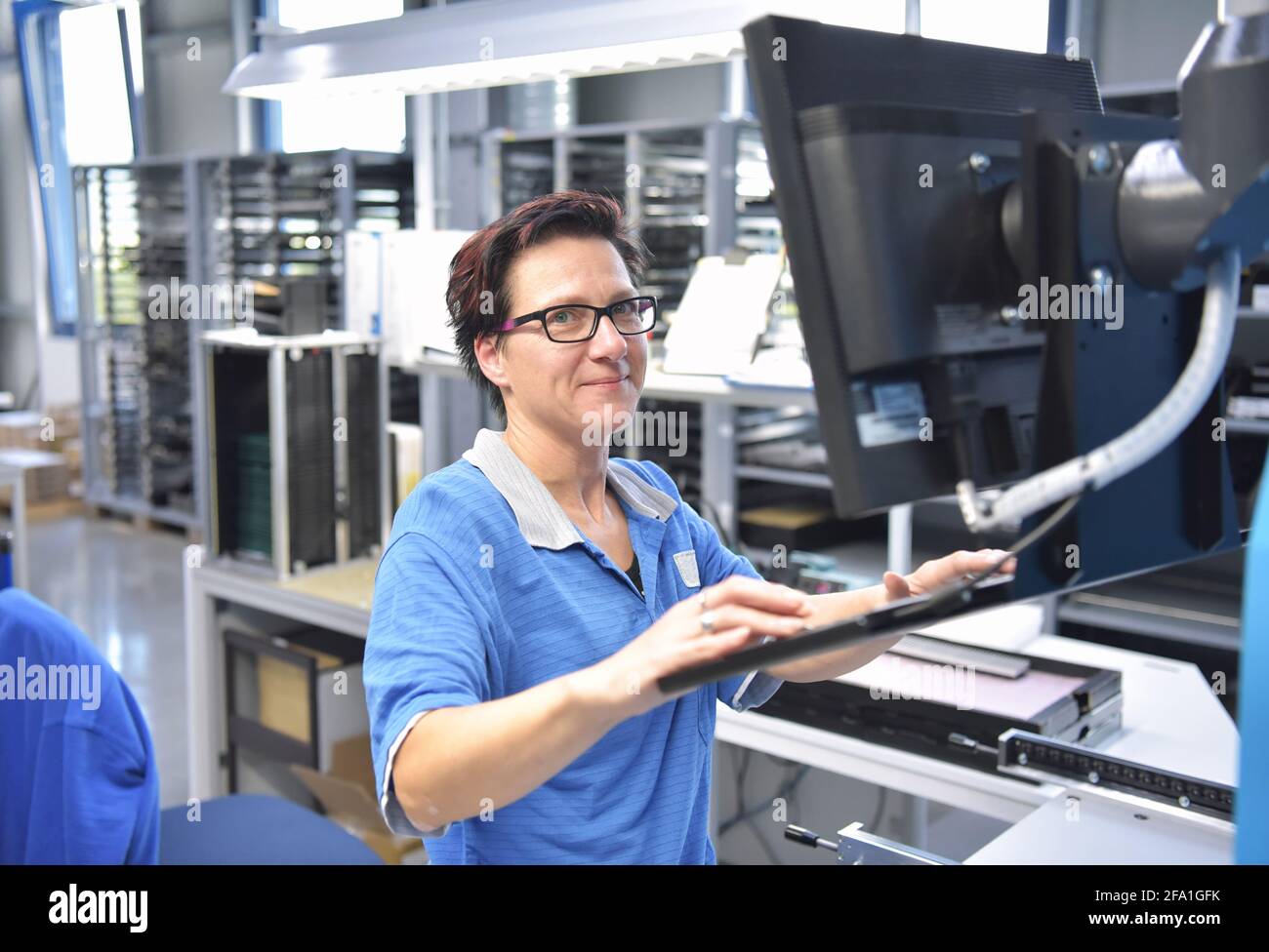 woman works in the production of a factory for electronics - operation ...