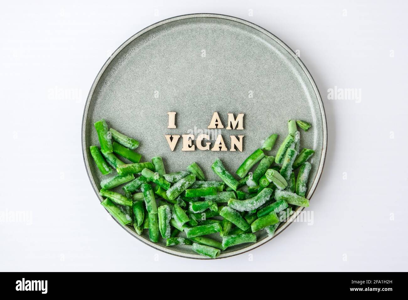 I AM VEGAN text in plate. Veganism, vegetarian healthy lifestyle green ...