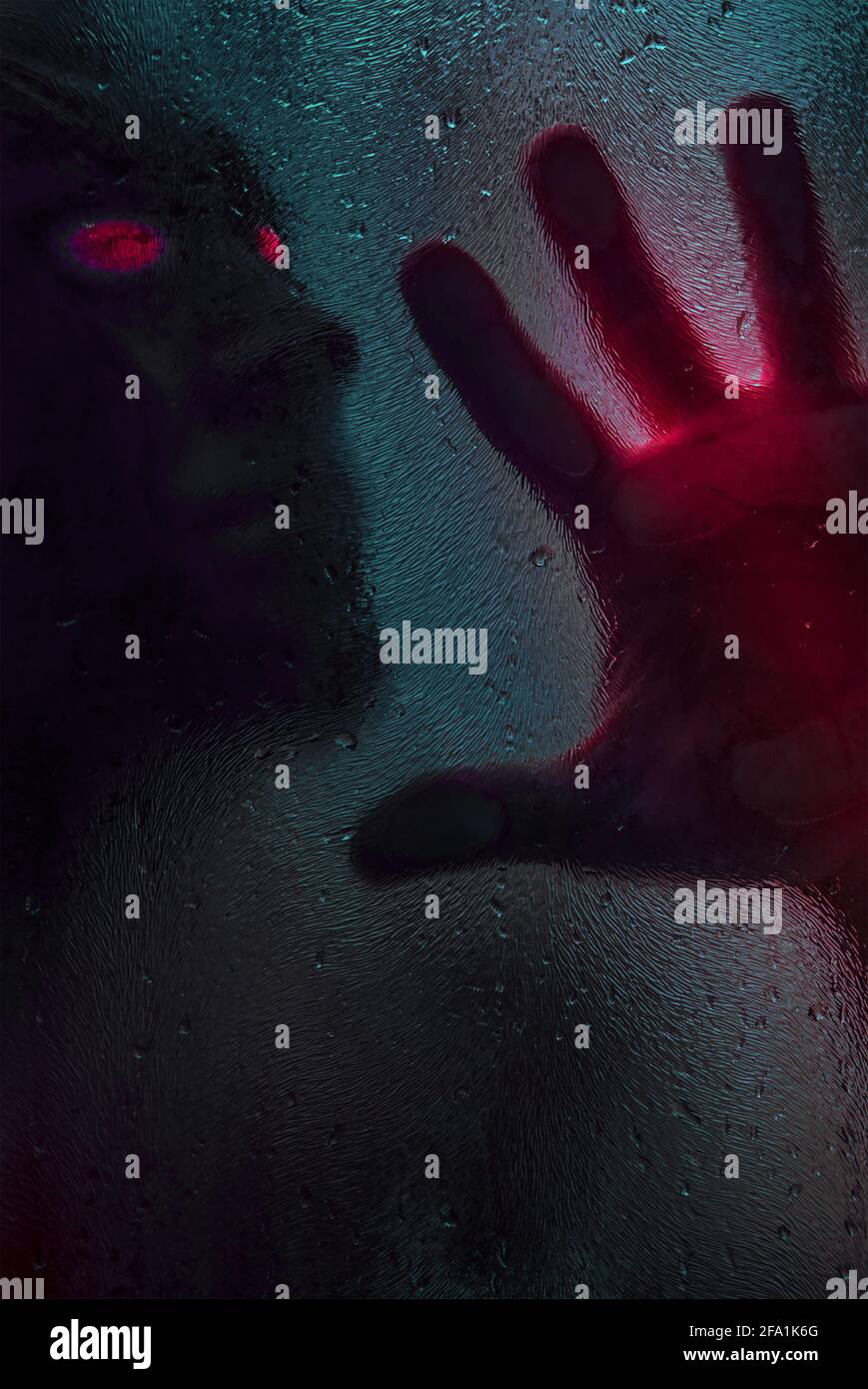 Horror scene of a man with bloody hand against wet shower glass. Toned ...