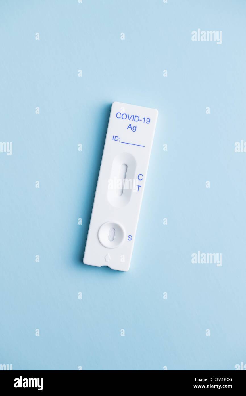 Covid-19 rapid antigen test. Rapid antibodies test kit on blue ...