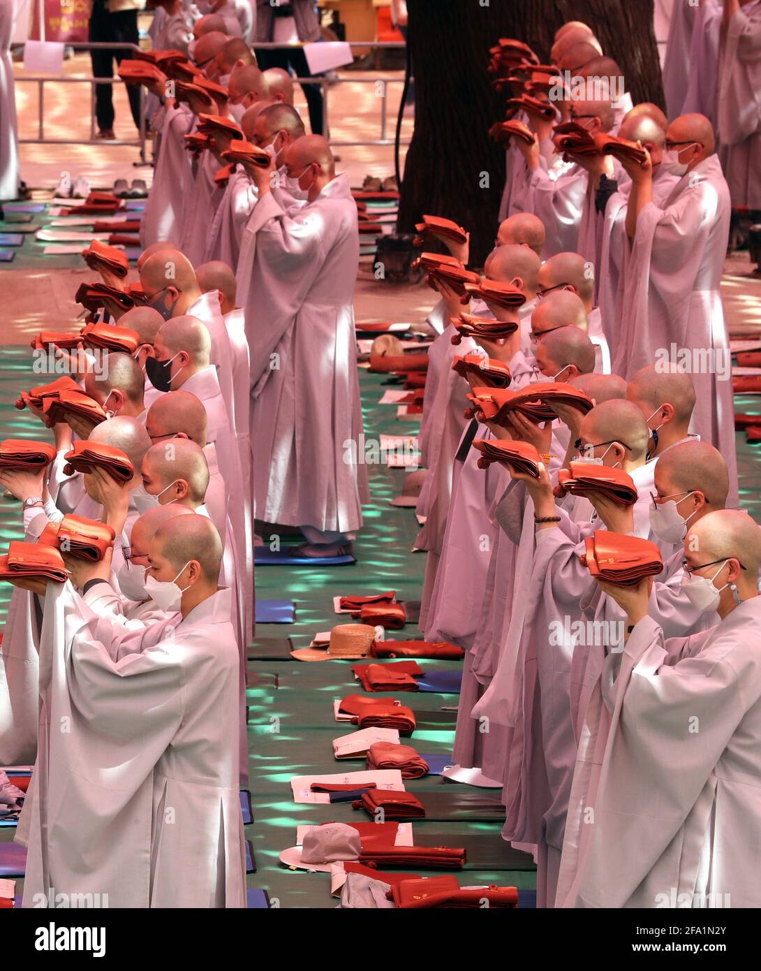22nd Apr, 2021. Buddhist ordination Buddhist monks and nuns hold up ...