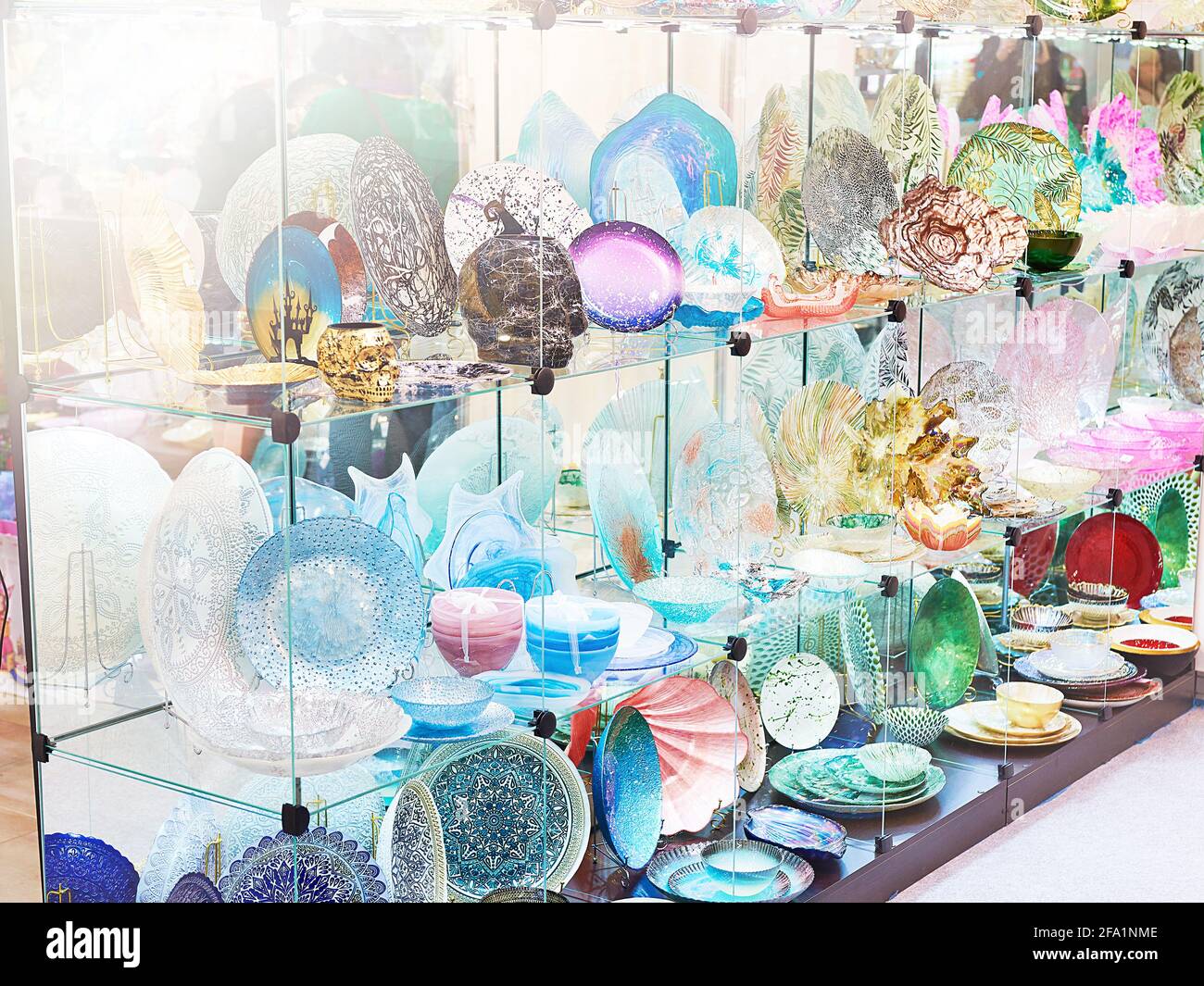 Decorative colored glass dishes in the store Stock Photo - Alamy