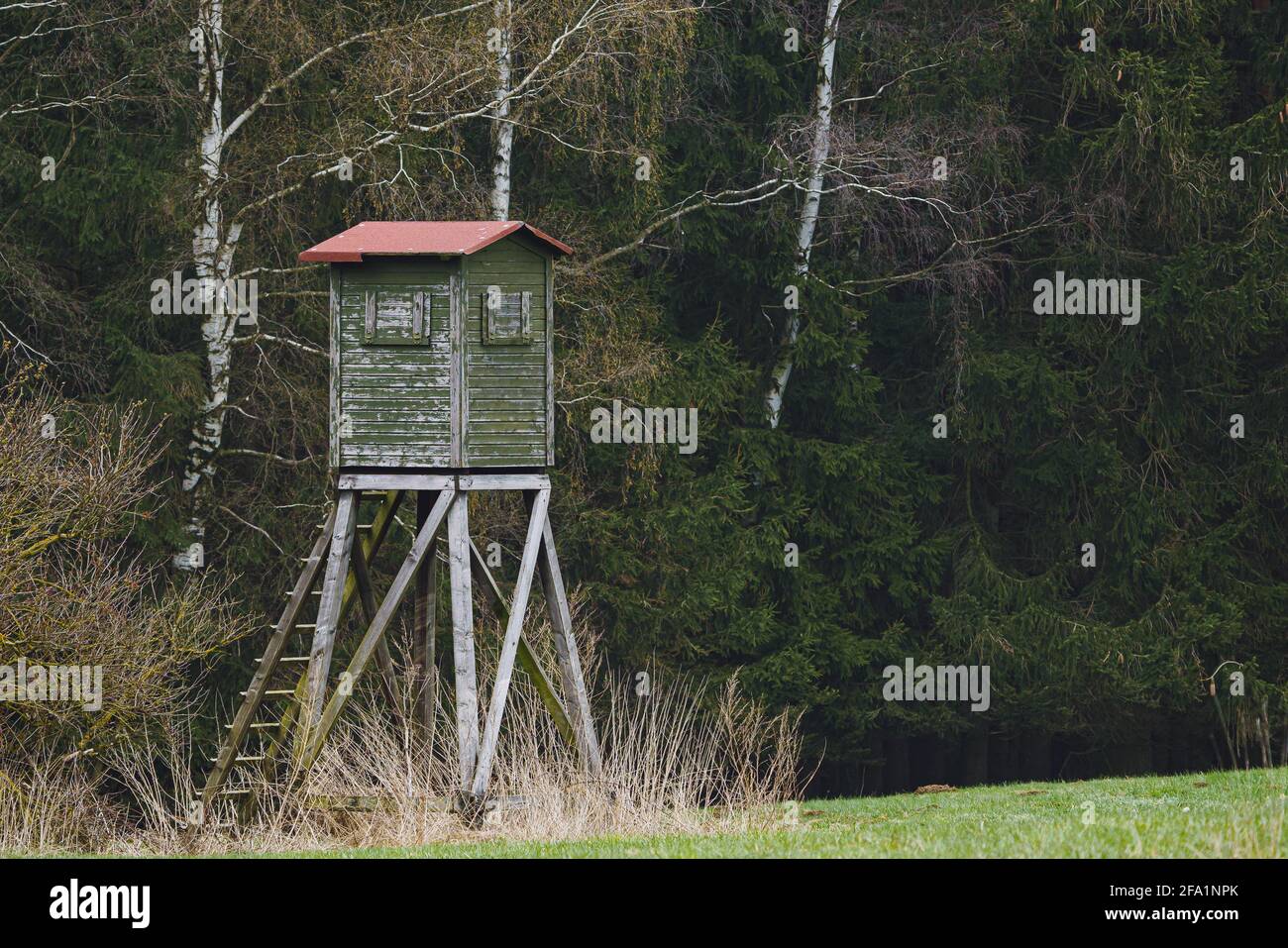 Wooden lookout tower for hunting in the woods and on meadow Stock Photo ...
