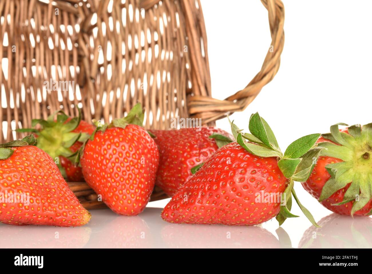 One whole and one cut in half, ripe strawberries, close-up, on a white ...