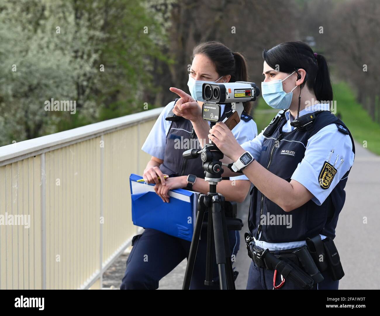 Ludwigsburg, Germany. 21st Apr, 2021. Two policewomen use a speedometer ...