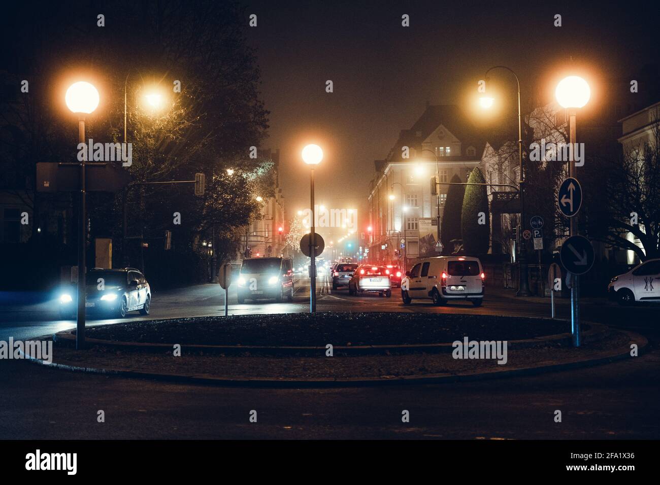 Avenue (road) during a rainy night in Munich, Bavaria, Germany. Traffic ...