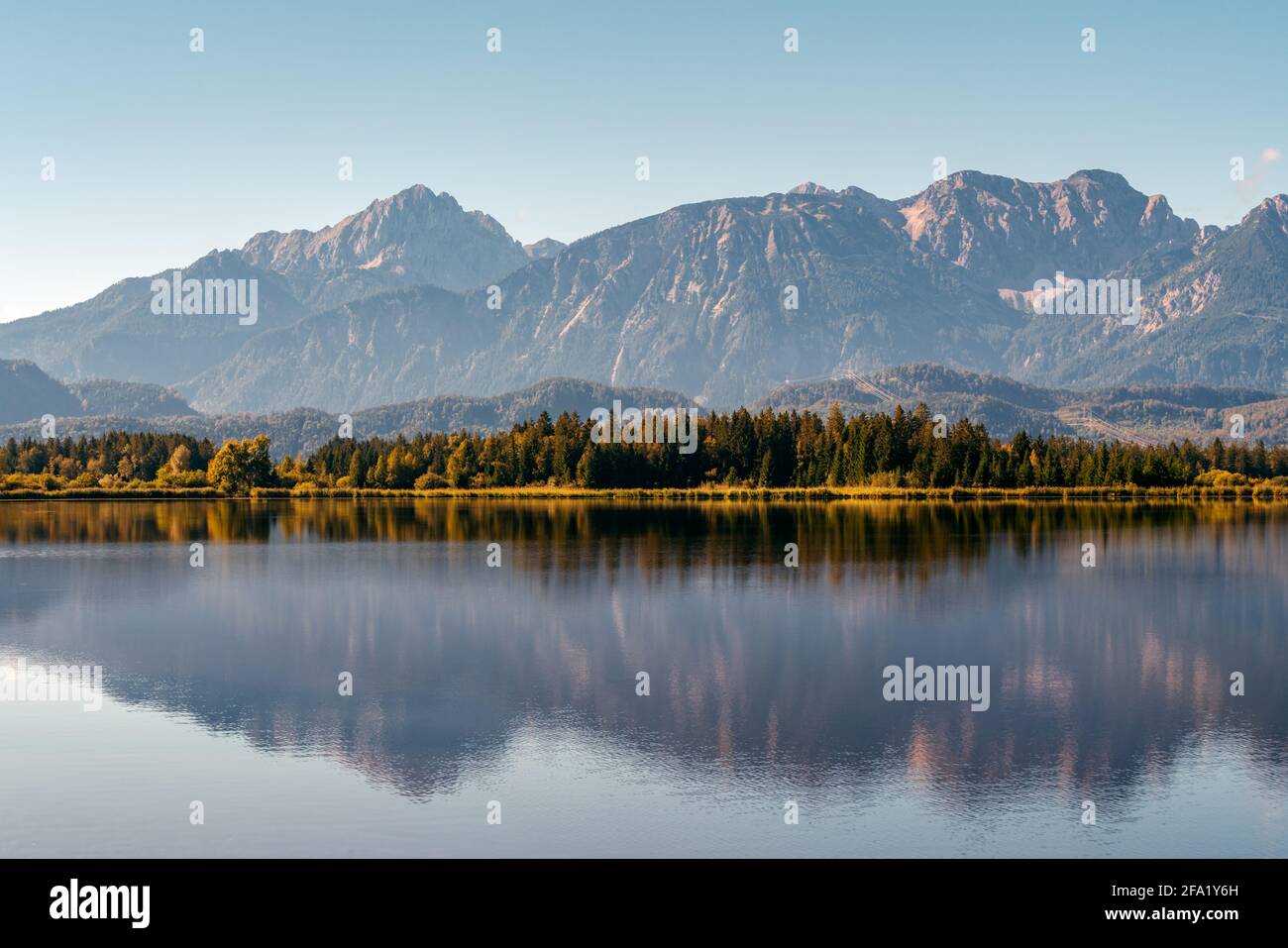 Soothing reflections in Hopfensee lake in Bavaria, Germany. View of the ...