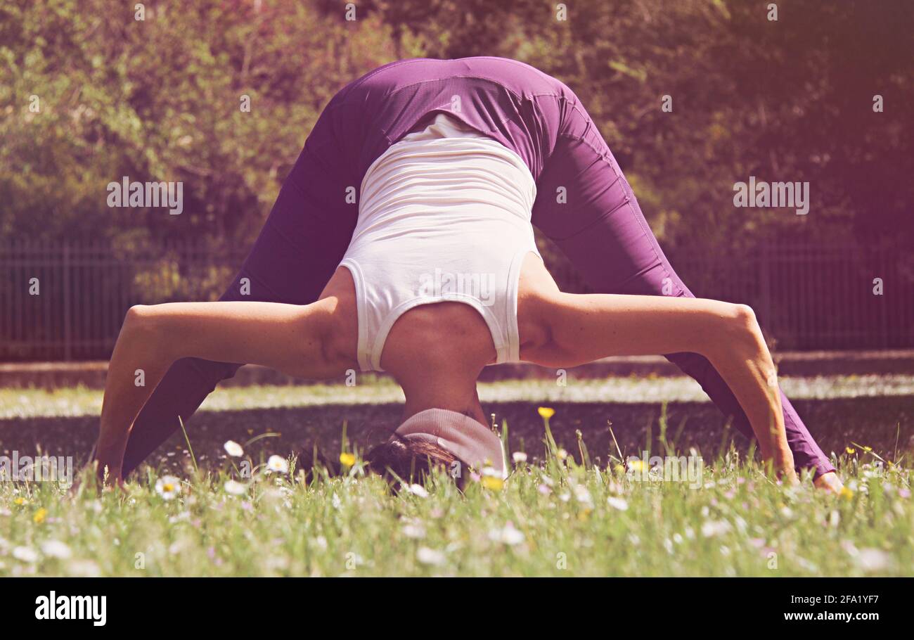 Woman at the park in a headstand position Stock Photo - Alamy