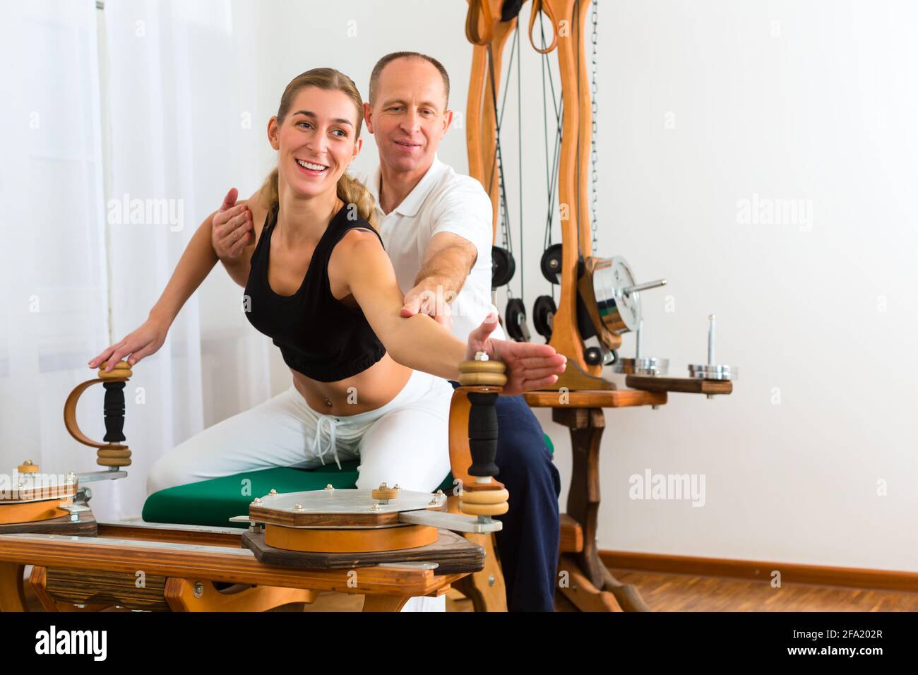 Patient at the physiotherapy making physical exercises Stock Photo - Alamy