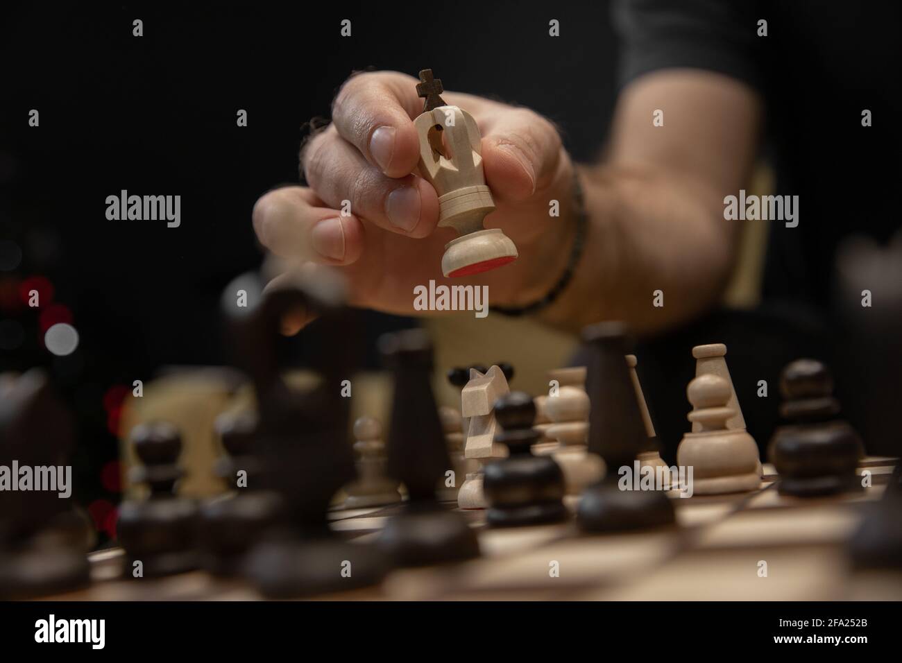 Man taking next step on chess game. Human hand moving wooden white ...