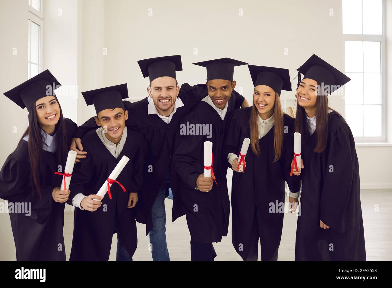 Group of classmates university graduates feeling happy with successful ...