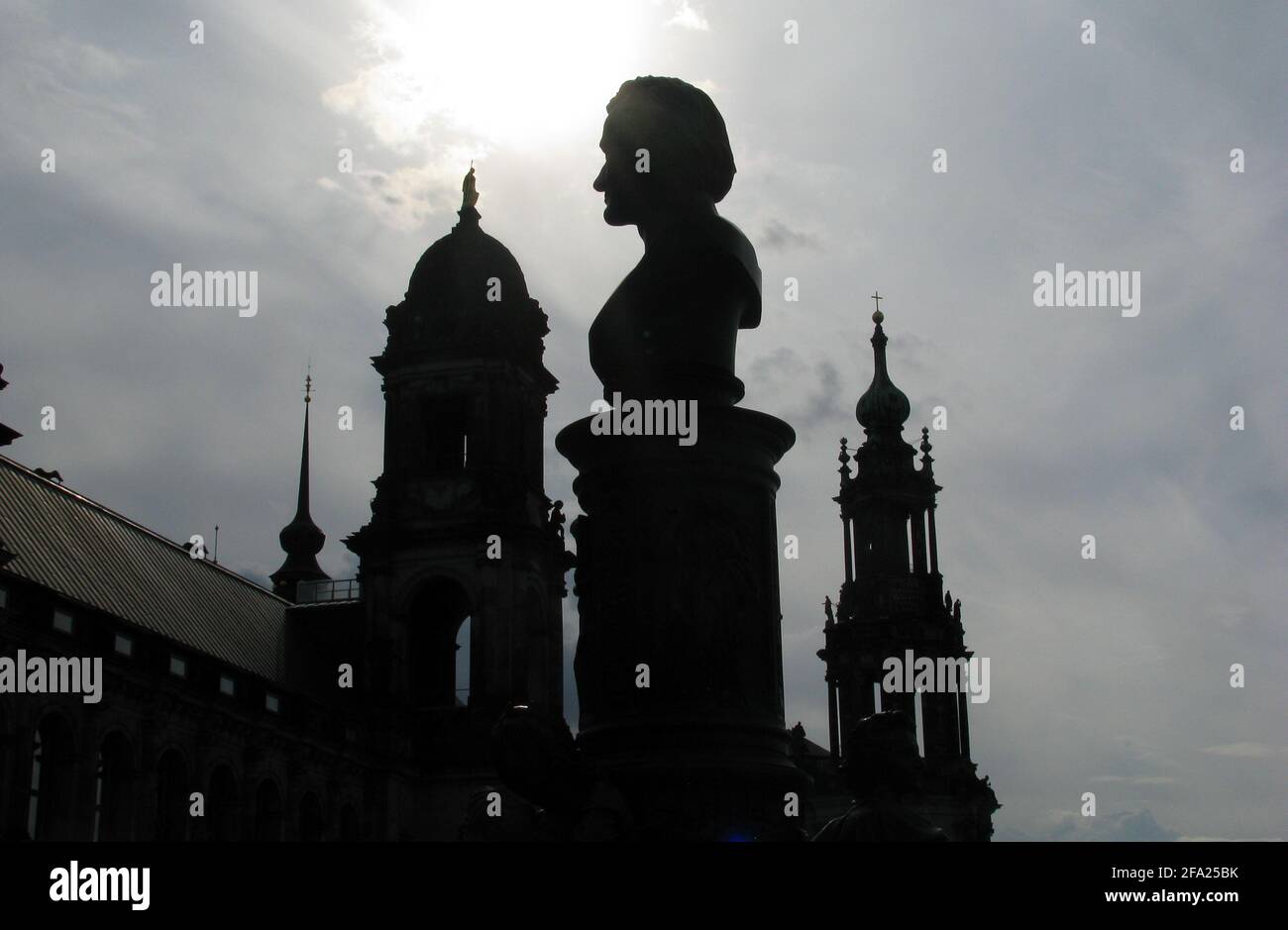 statue and historical towers in backlight in the old town of Dresden ...