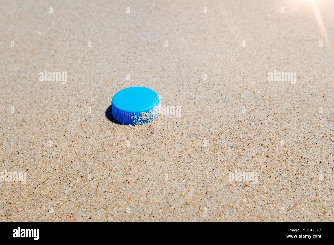 Plastic plug on the clean sand of a beach Stock Photo - Alamy