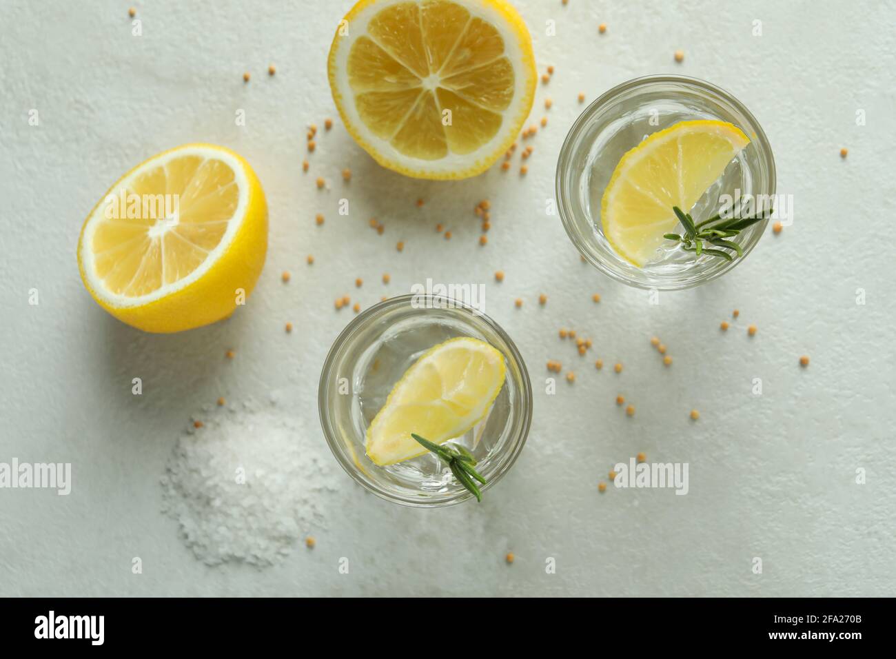 Shots of tequila on white textured table Stock Photo - Alamy