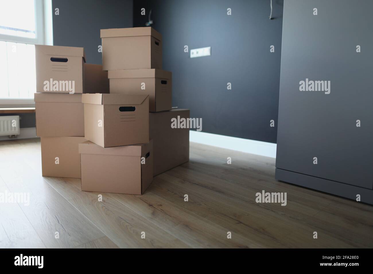 Cardboard boxes in empty room. Services of transport and logistics ...