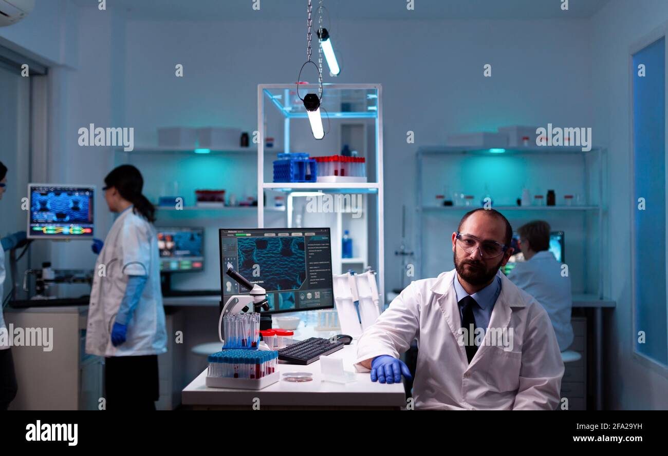 Portrait of man scientist in research laboratory looking at the camera ...
