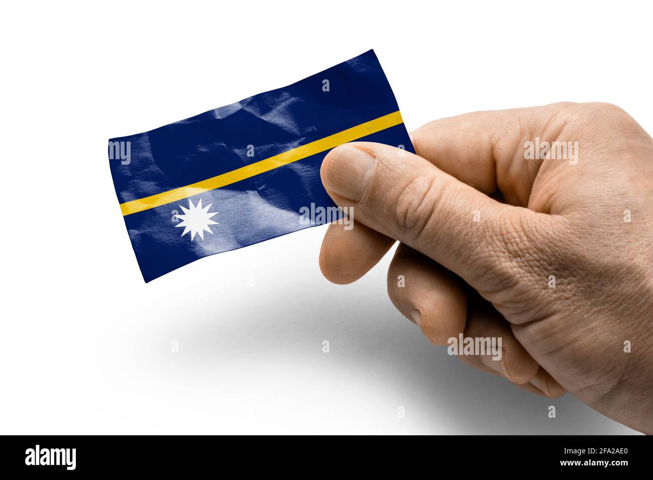 Hand holding a card with a national flag the Nauru Stock Photo - Alamy