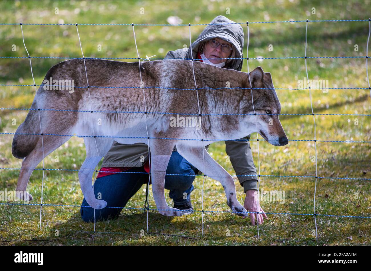 Schwerin, Germany. 22nd Apr, 2021. A participant hangs a photo of a ...