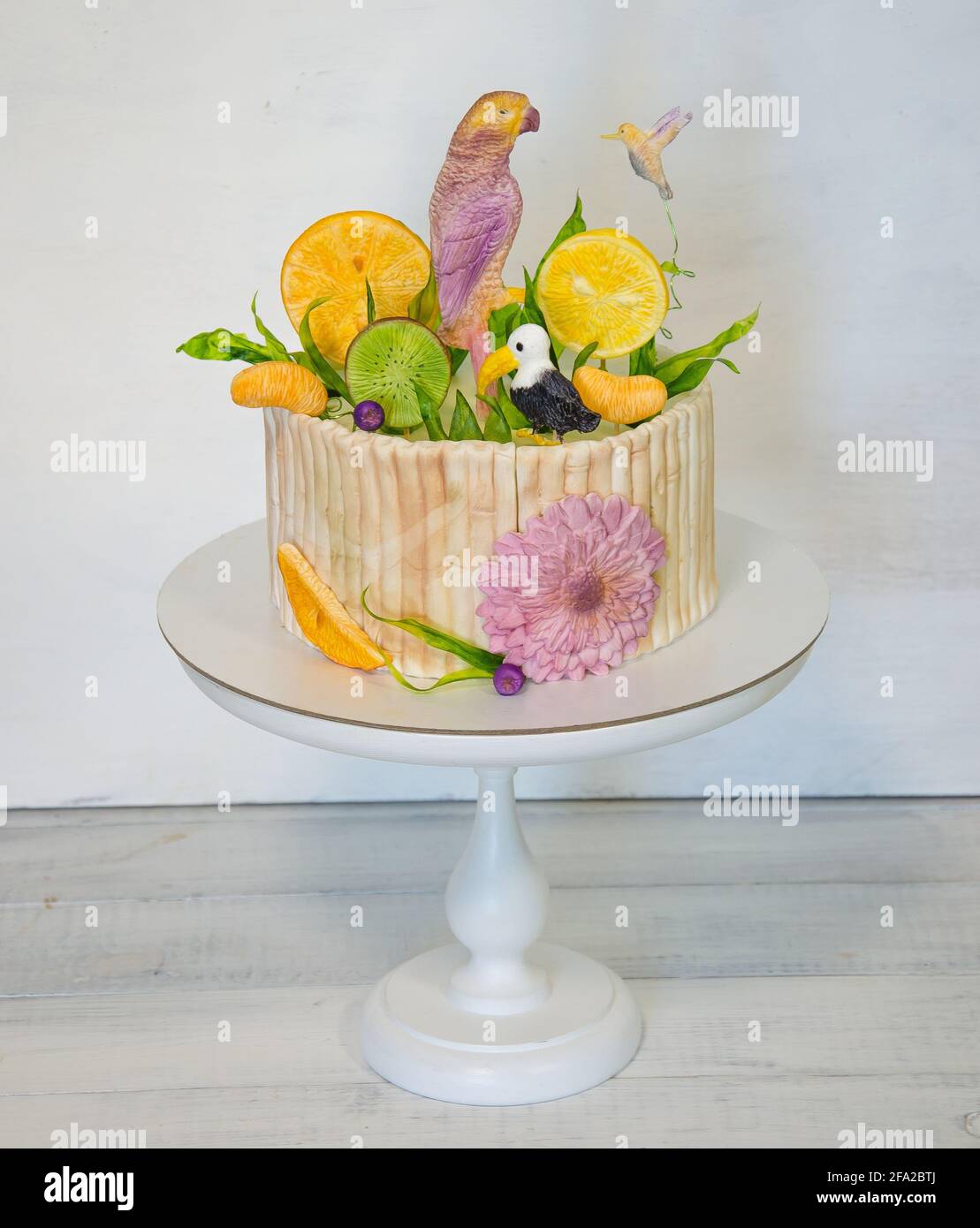 A beautiful fondant cake with parrot and tropical fruit Stock Photo - Alamy