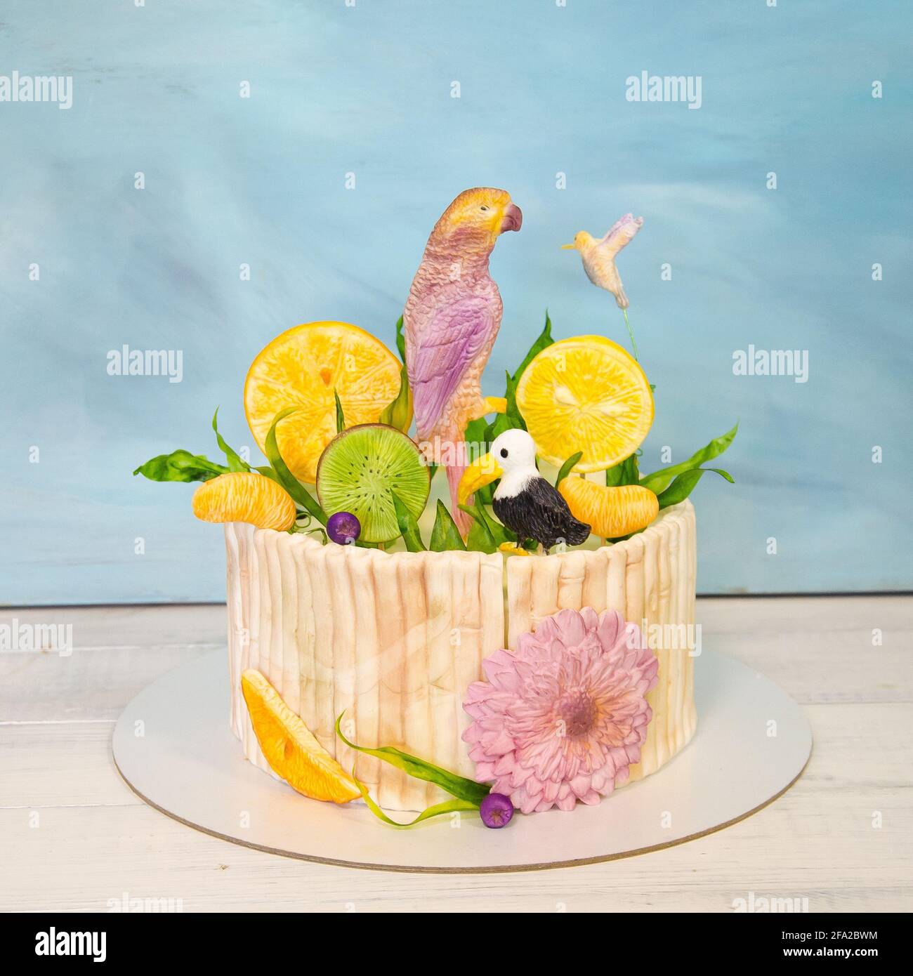 A beautiful fondant cake with parrot and tropical fruit Stock Photo - Alamy