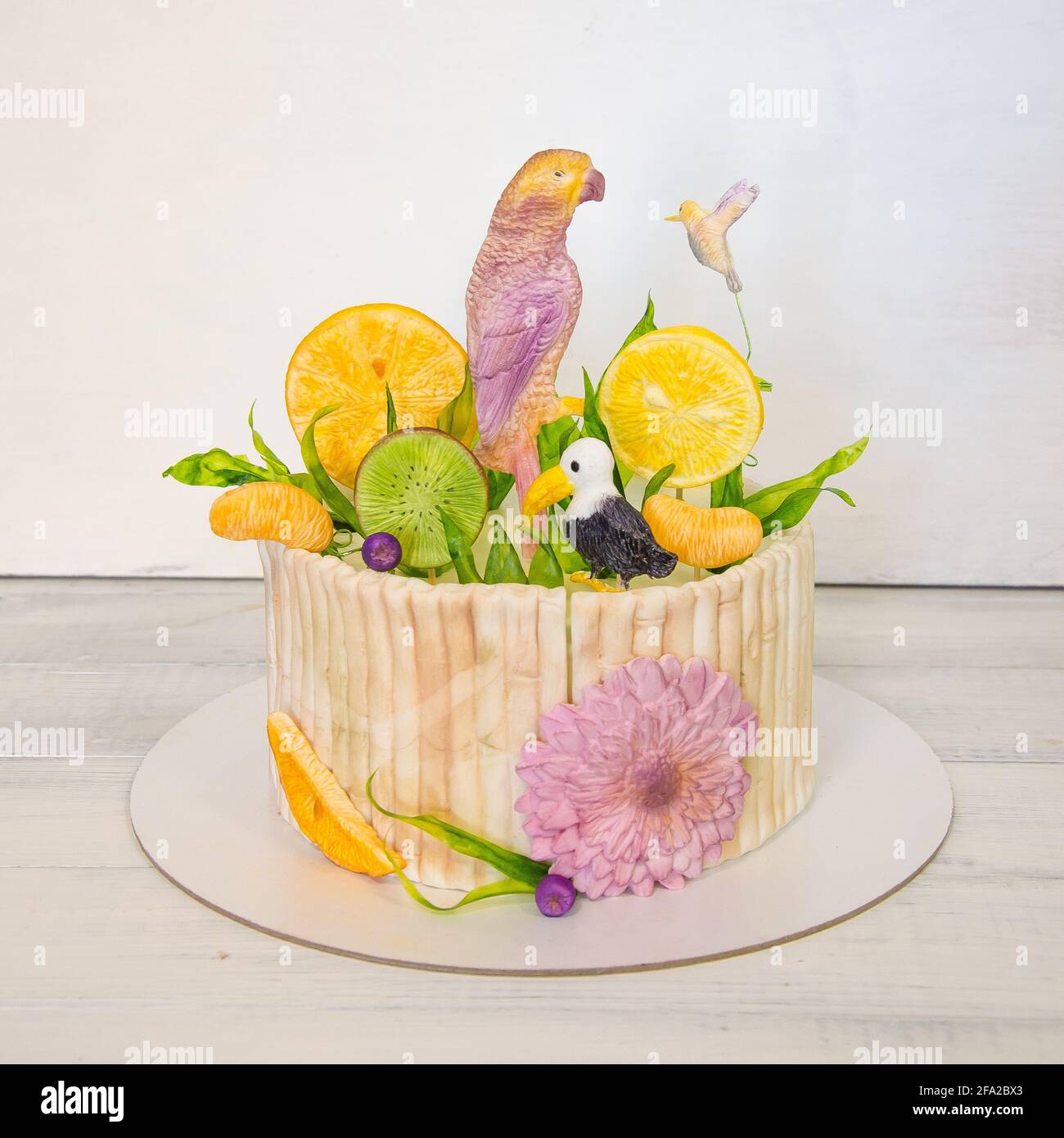 A beautiful fondant cake with parrot and tropical fruit Stock Photo - Alamy