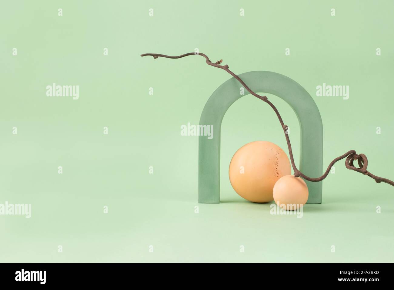 Modern still life composition with modern plaster shapes and dry twig ...