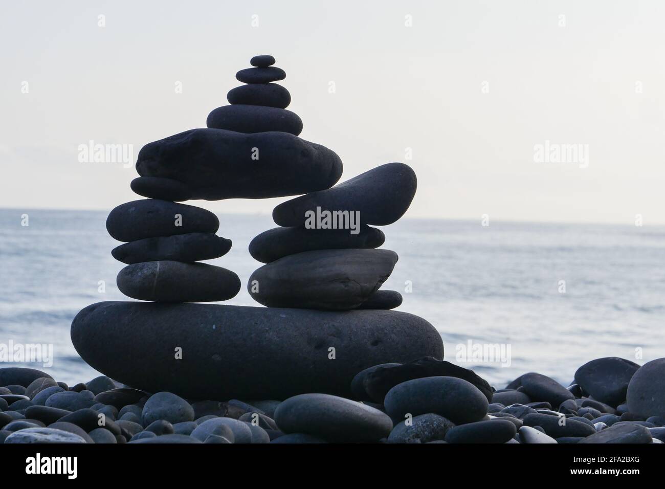 Stone piles made along a beach and the sea in the background Stock ...