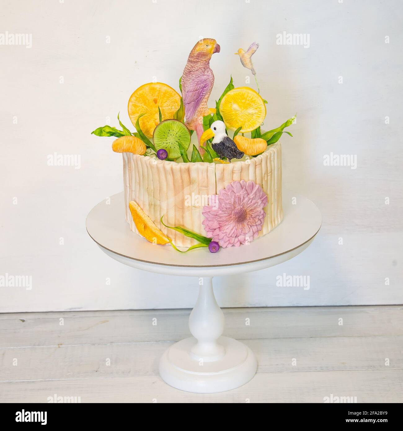 A beautiful fondant cake with parrot and tropical fruit Stock Photo - Alamy