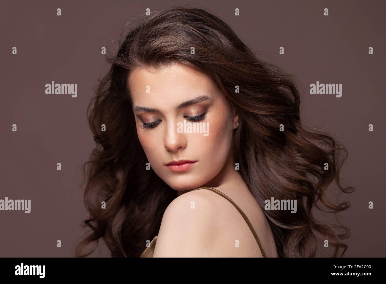 Portrait of lovely woman brunette with clear skin and healthy wavy ...