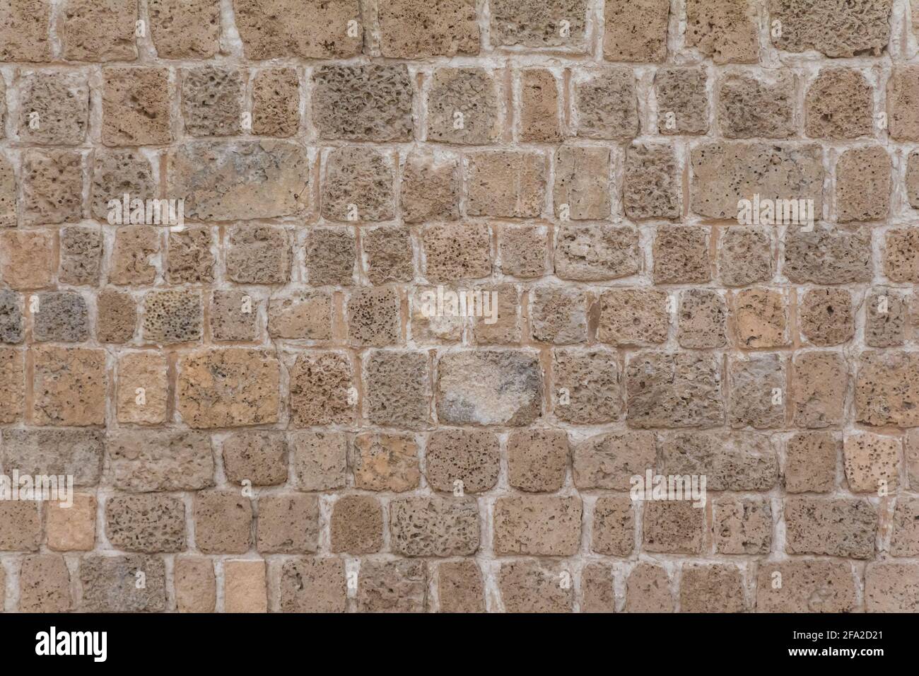 Old stable stone wall with rows of crafted masonry stones. Brickwork ...
