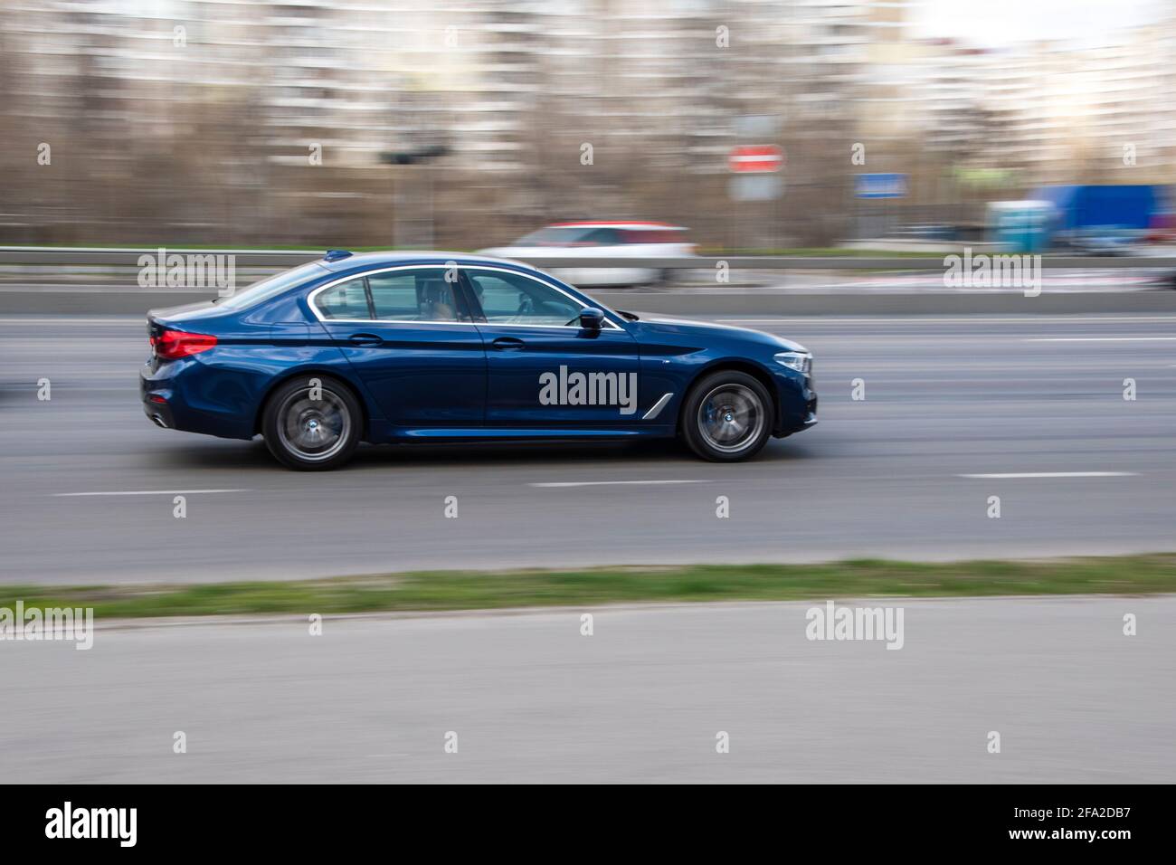Ukraine, Kyiv - 6 April 2021: Blue BMW 5 Series car moving on the ...