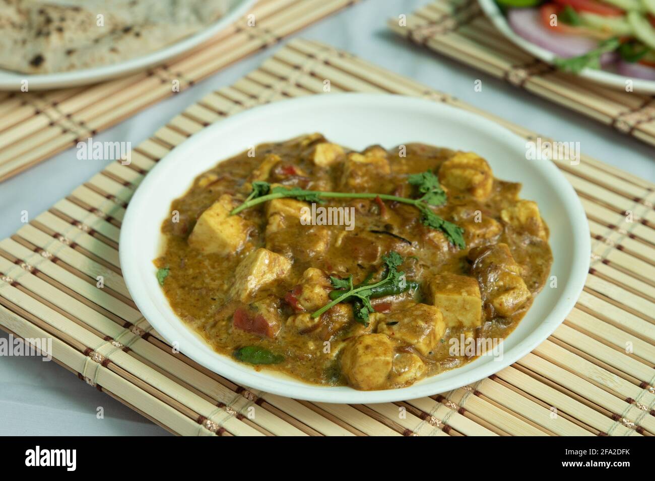 Delicious paneer butter masala on a white plate Stock Photo - Alamy