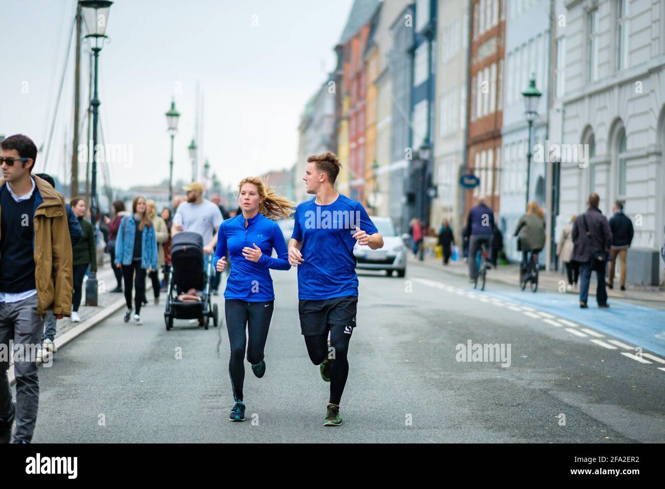 Copenhagen, Denmark 10 May 2018. A couple jogging in the Nyhavn area ...