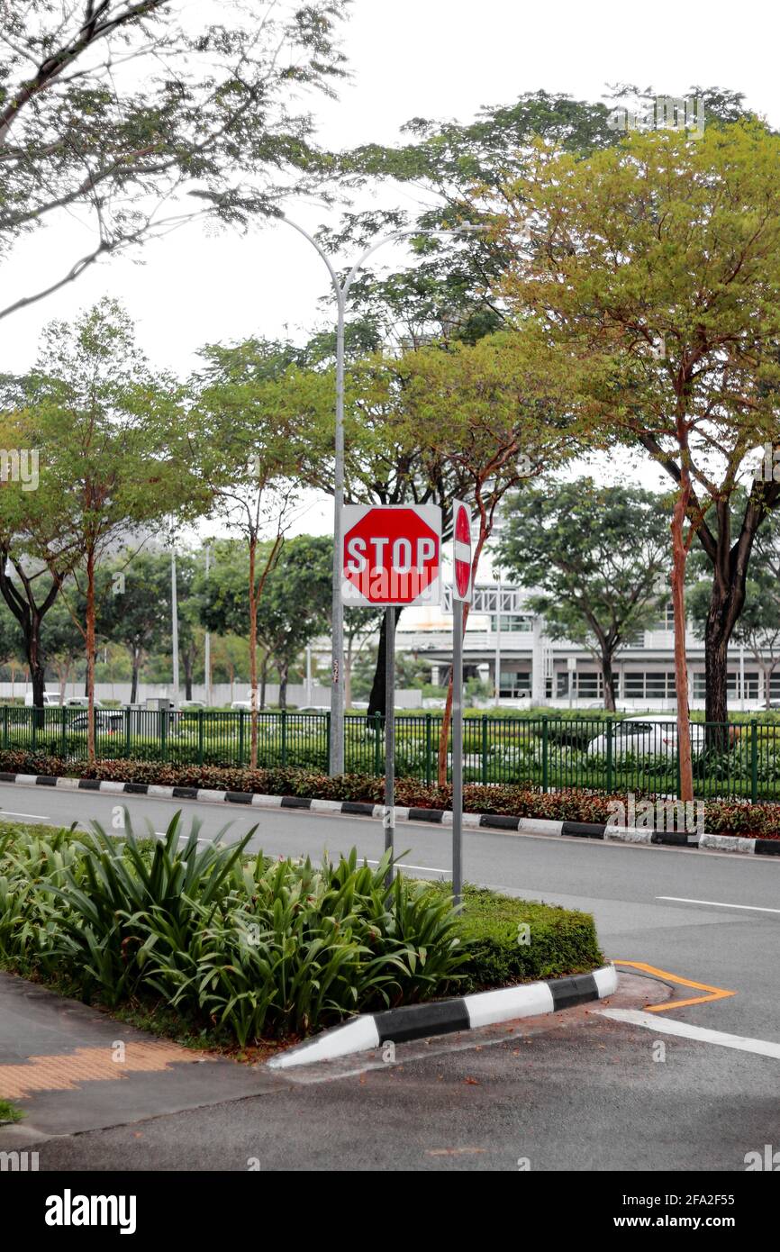 Vertical of the red-colored "STOP" traffic sign on the road Stock Photo ...