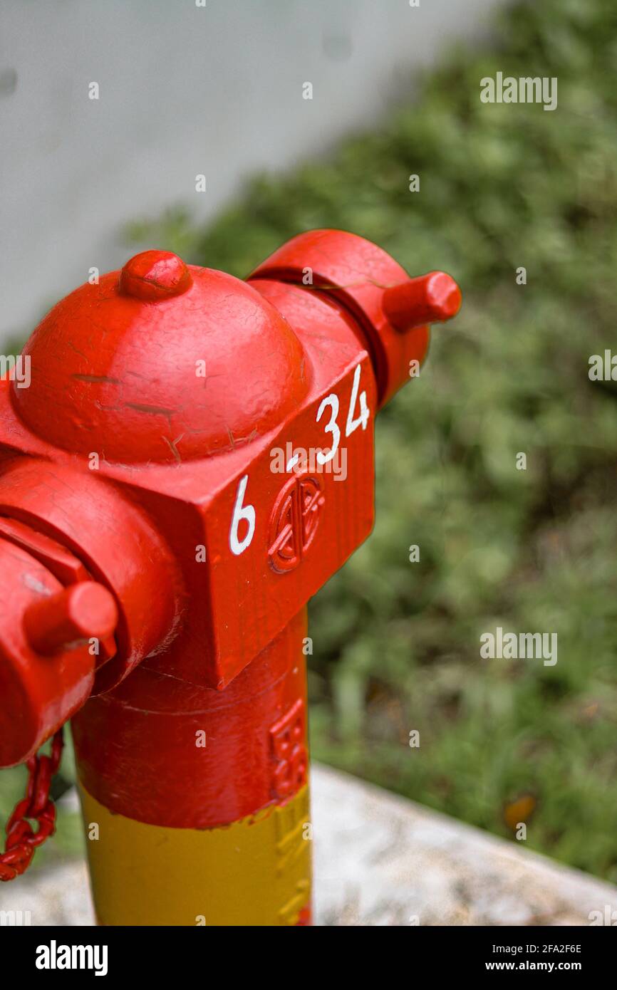 Closeup of a red painted metal fire hydrant on the concrete in the ...