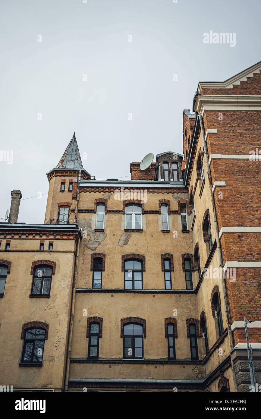 Low angle of a weathered old fashioned brown high rise building in the ...
