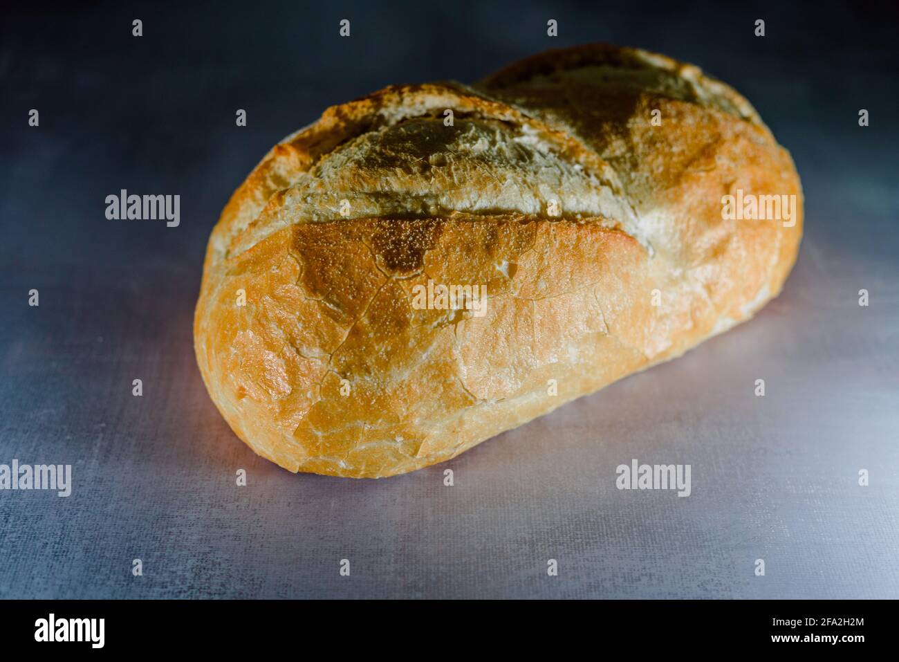 Fresh loaf of bread on the light gray surface Stock Photo - Alamy
