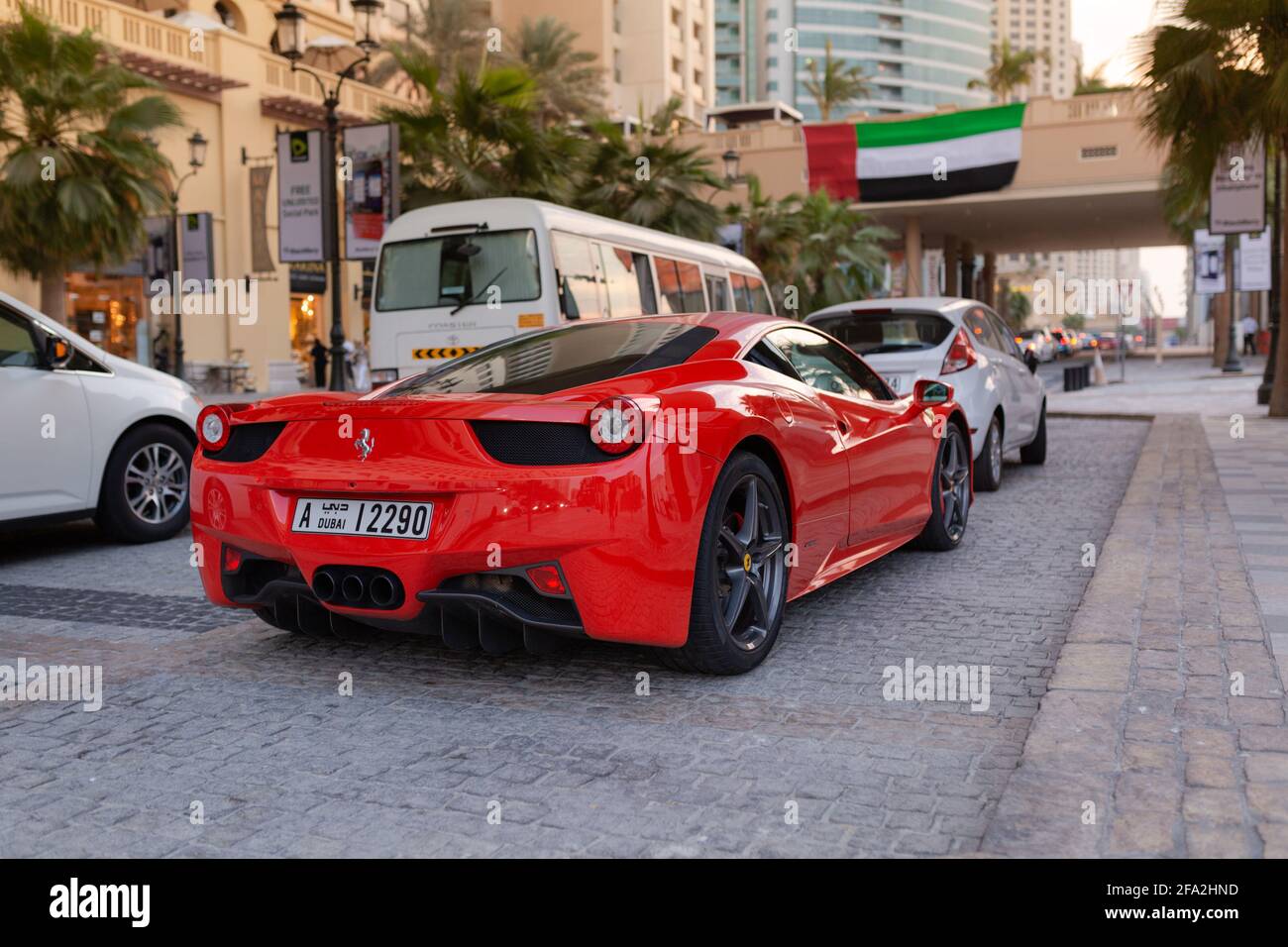 Dubai, UAE - November 20, 2013. Red Ferrari driving in Dubai Maria ...