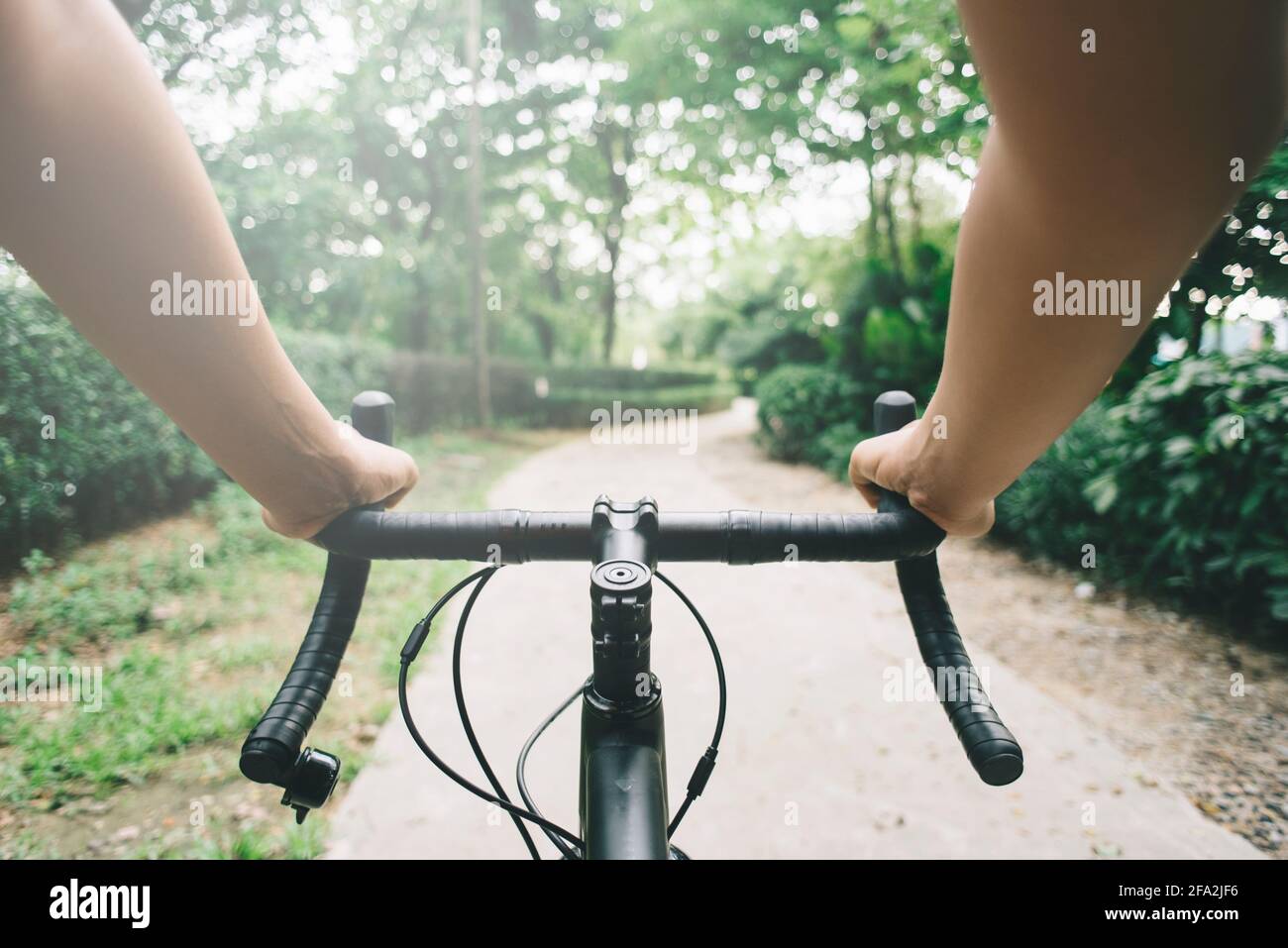 View of bicycle handle bar againts nature path park. Concept of Healthy ...