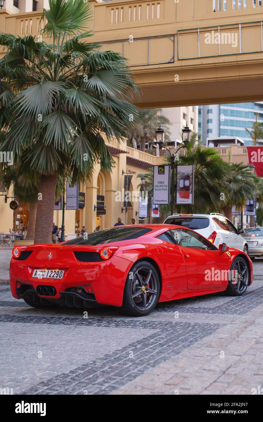 Dubai, UAE - November 20, 2013. Red Ferrari driving in Dubai Maria ...