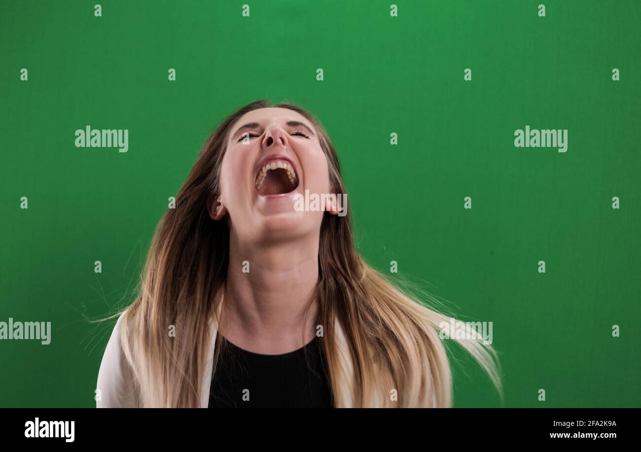 Young woman laughs very loudly Stock Photo - Alamy