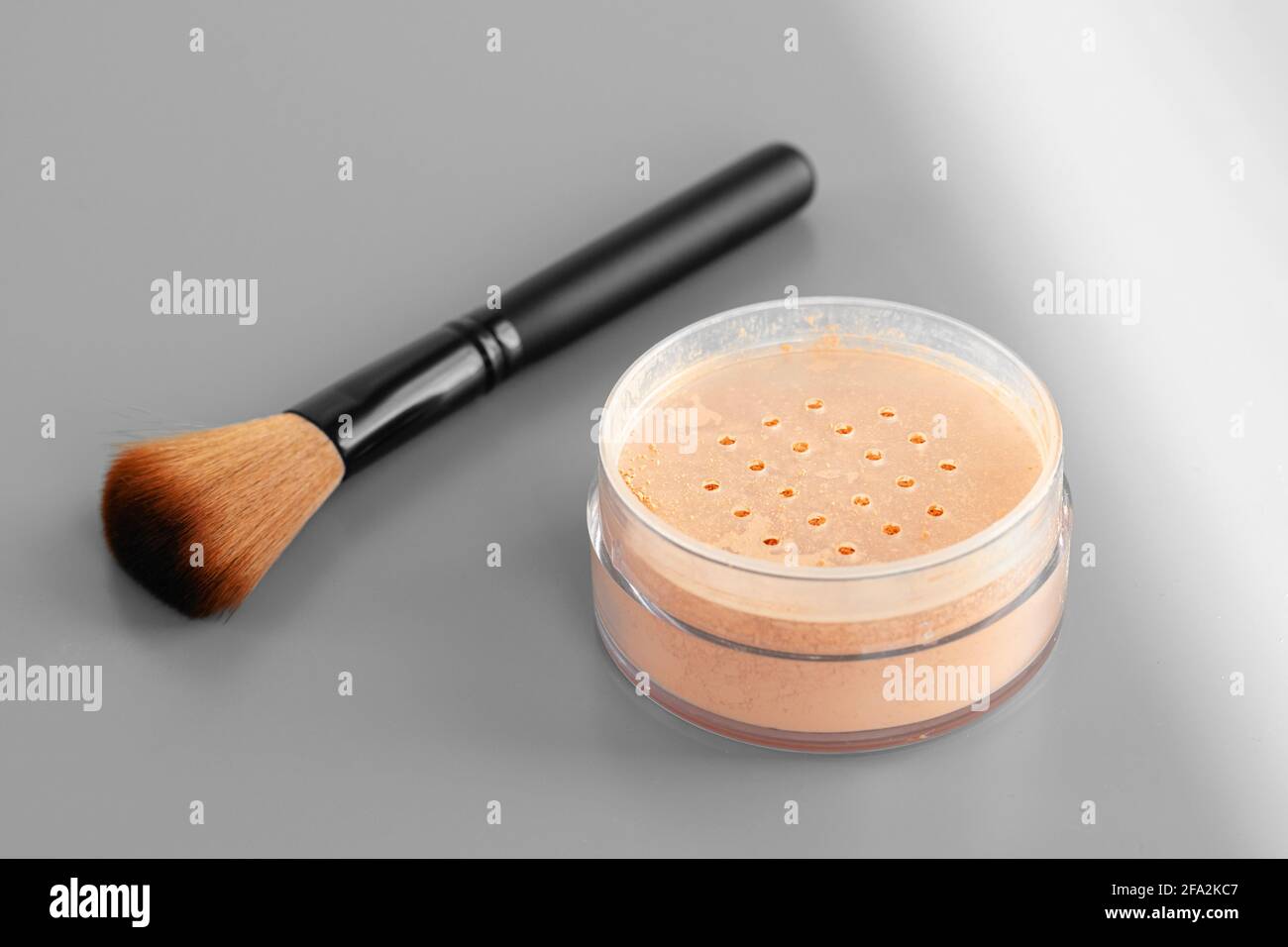 Open loose powder container on table close up Stock Photo - Alamy