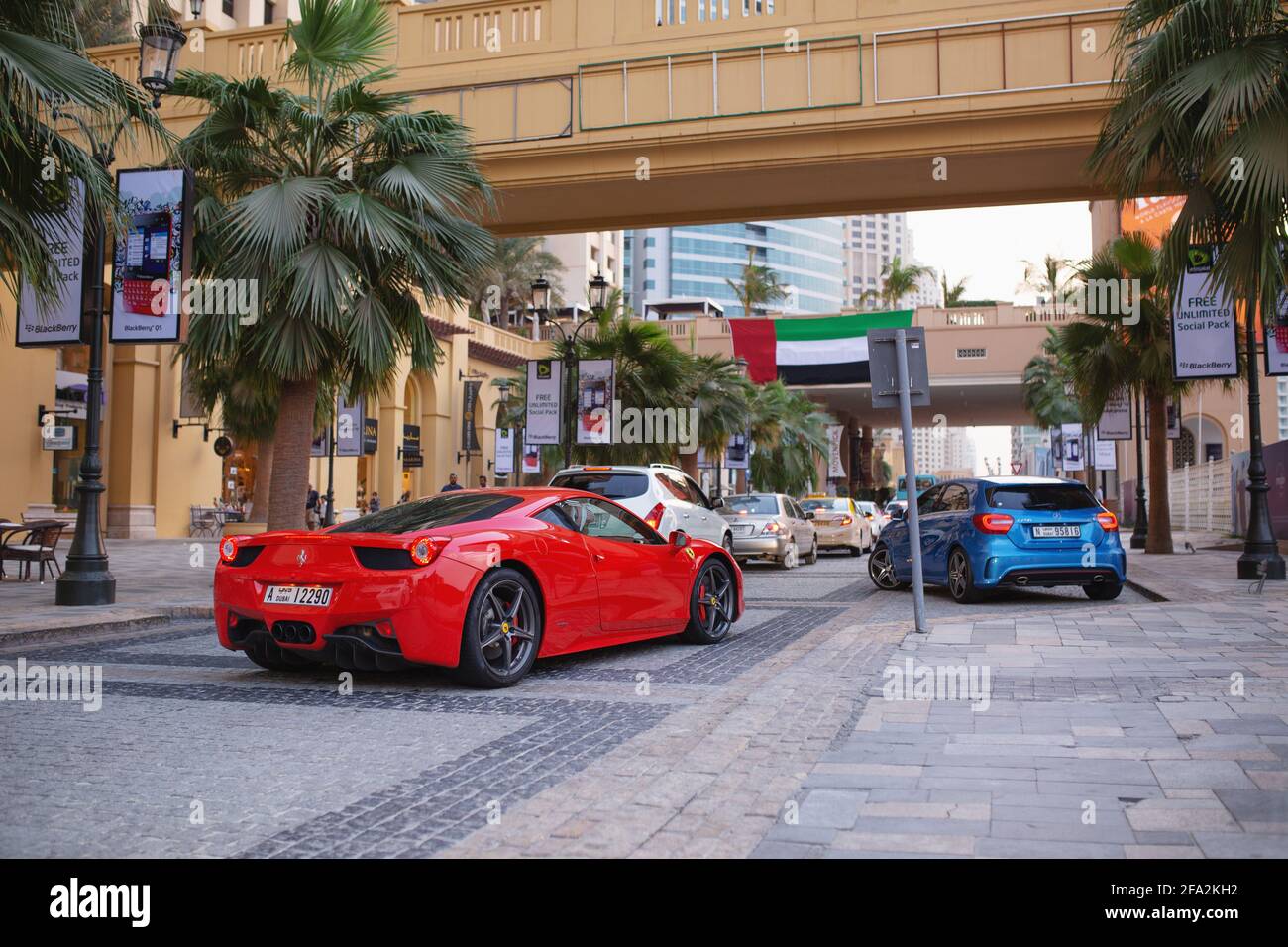 Dubai, UAE - November 20, 2013. Red Ferrari driving in Dubai Maria ...