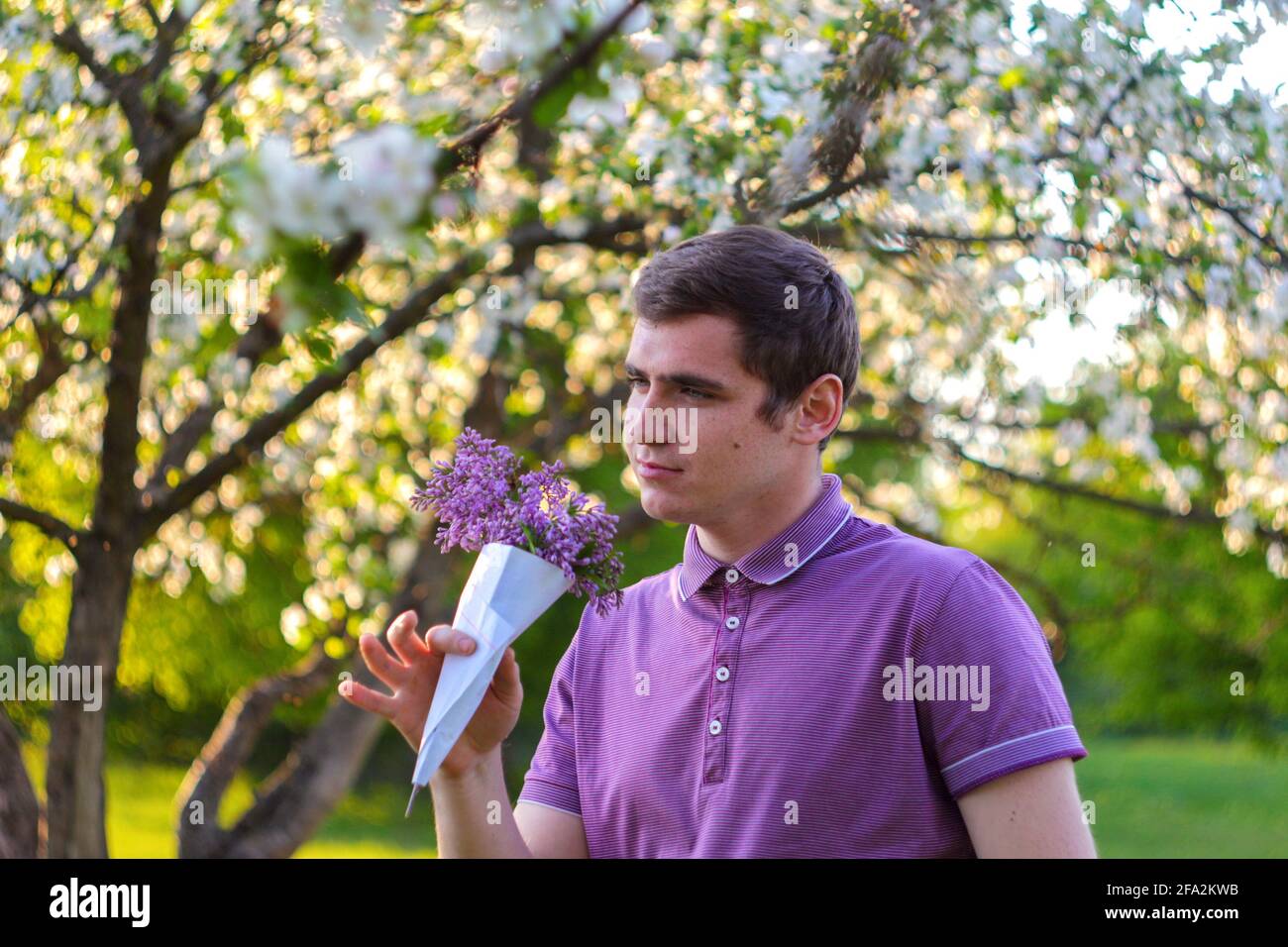 Defocus portrait of handsome caucasian man with cone flowers in purple ...