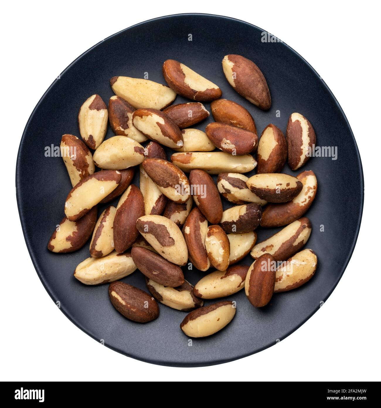 shelled brazilian nuts on isolated black ceramic plate, top view Stock ...