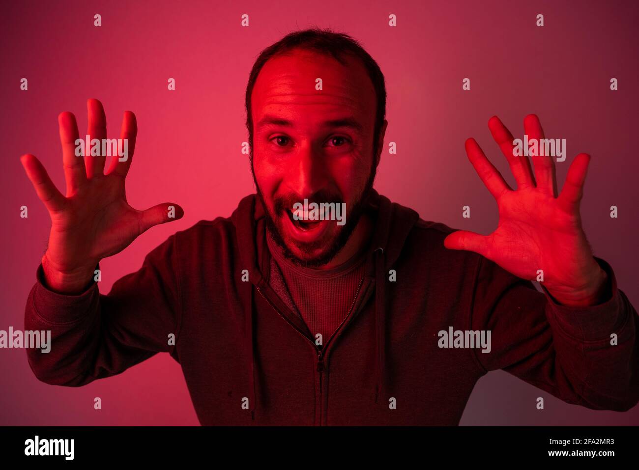 concept af angry and abusive man with red light. studio portrait of ...