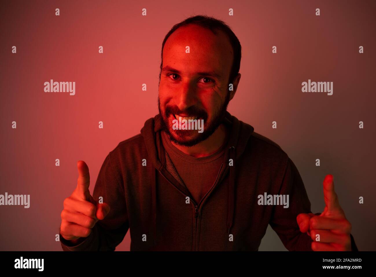 concept af angry and abusive man with red light. studio portrait of ...