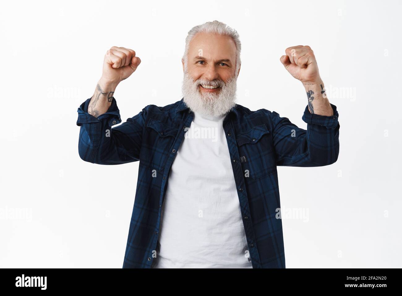 Celebrating old man with tattoos shouting yes with joy, shaking hands ...