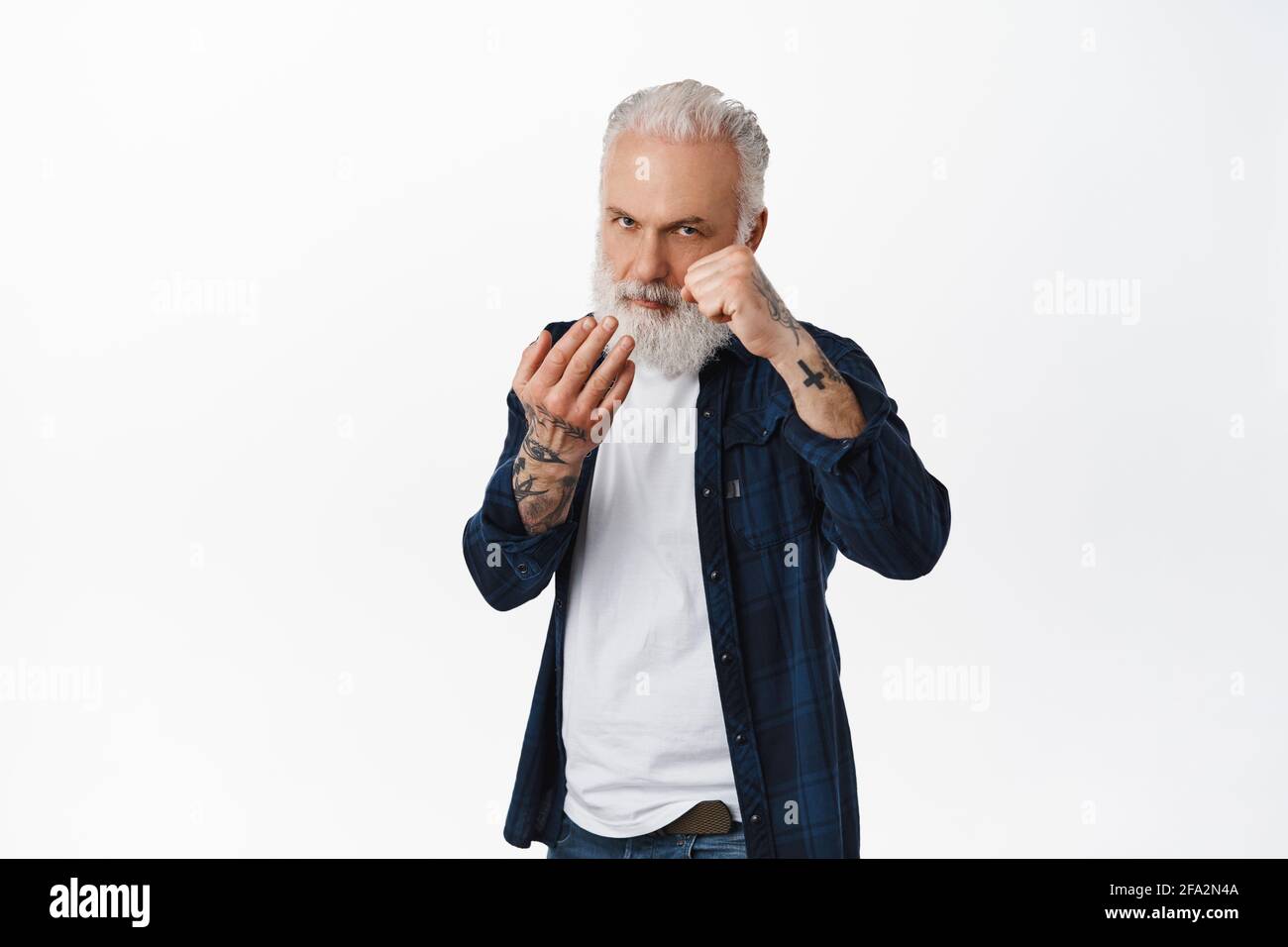 Serious mature man beckon to come closer and fight, going to punch ...