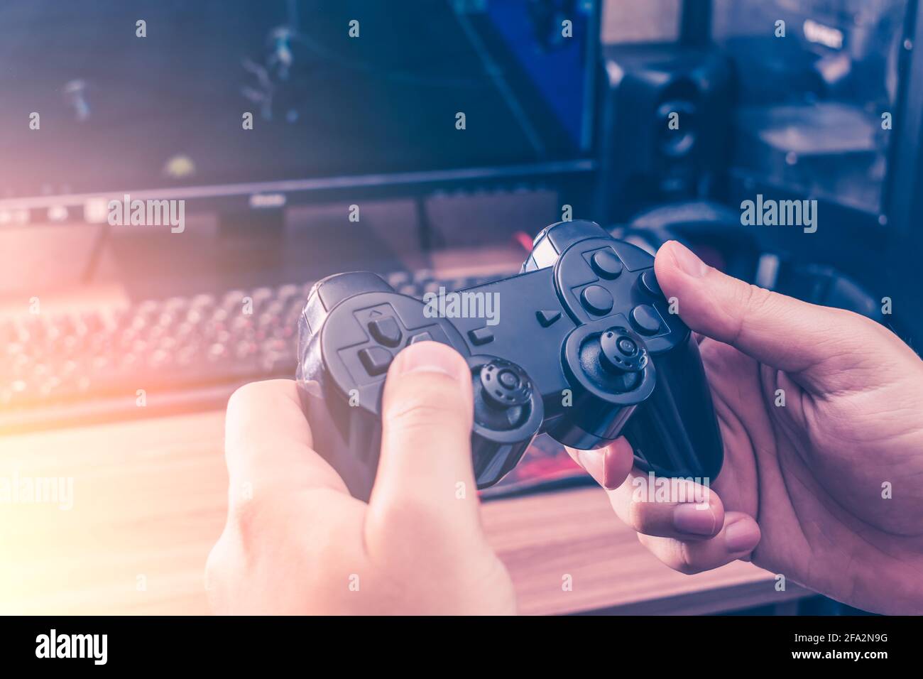 Game joystick in the hands of a teenager playing on the console Stock ...